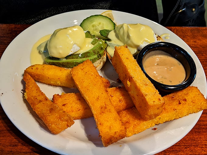Golden polenta fries stand at attention like delicious soldiers guarding eggs Benedict—a crispy, creamy textural masterpiece worth crossing state lines for.