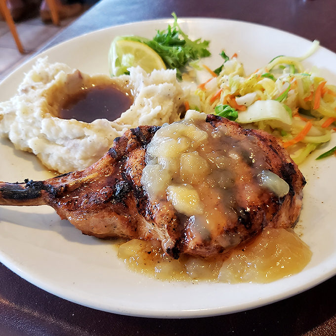 A pork chop that's been kissed by fire and blessed with apple chutney—comfort food that's dressed up but still knows where it came from.