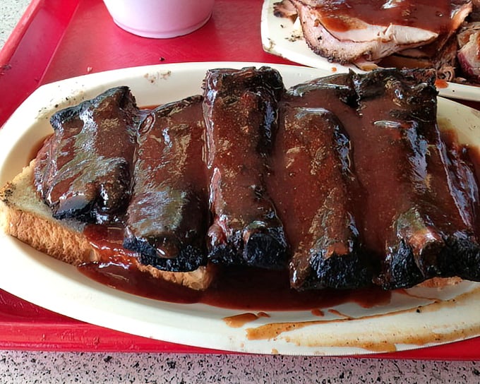 These ribs aren't "falling off the bone"—they're clinging to it just enough to remind you that proper barbecue has standards.