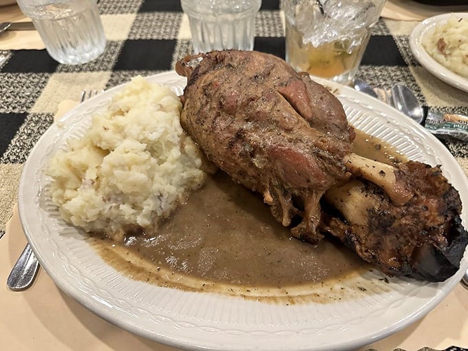 This pork shank isn't just fall-off-the-bone tender—it practically leapt off the bone to dive into that savory gravy lake. Mashed potato island included.