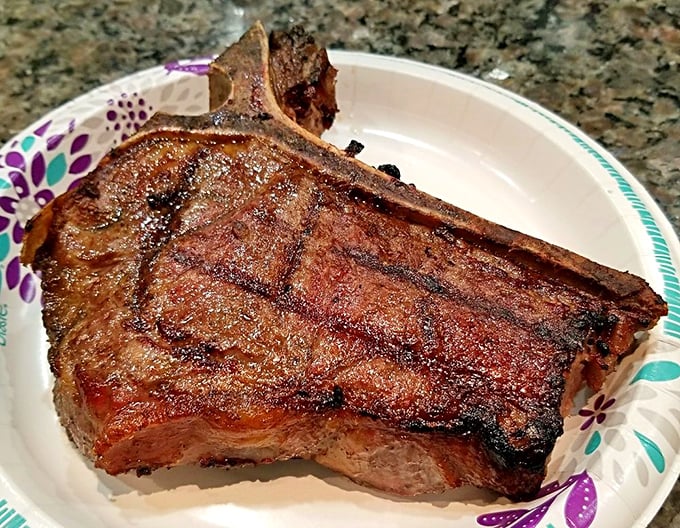 This isn't just a steak—it's a statement. The bone-in ribeye's marbling creates a buttery tenderness that makes conversation stop mid-sentence.