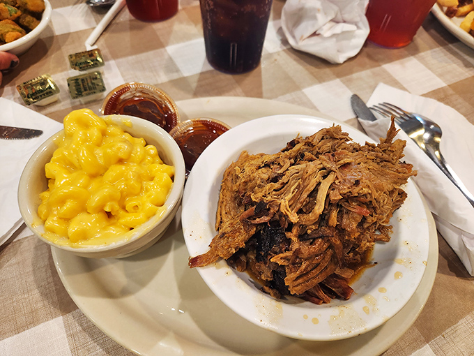 Pulled pork that doesn't need teeth to enjoy—it practically melts on contact. Paired with mac and cheese that glows like Florida sunshine.