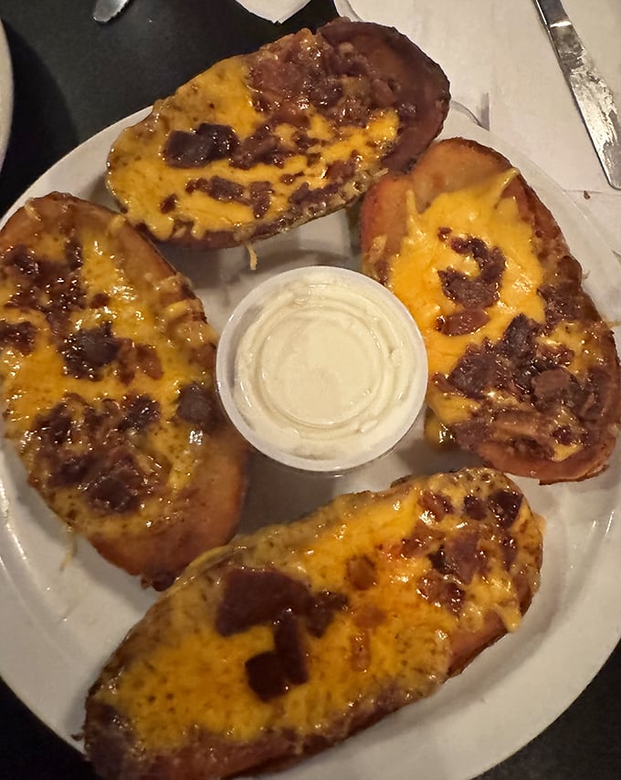 Potato skins loaded with melted cheese and bacon – the kind of appetizer that makes you wonder why we ever bothered inventing fancy food.