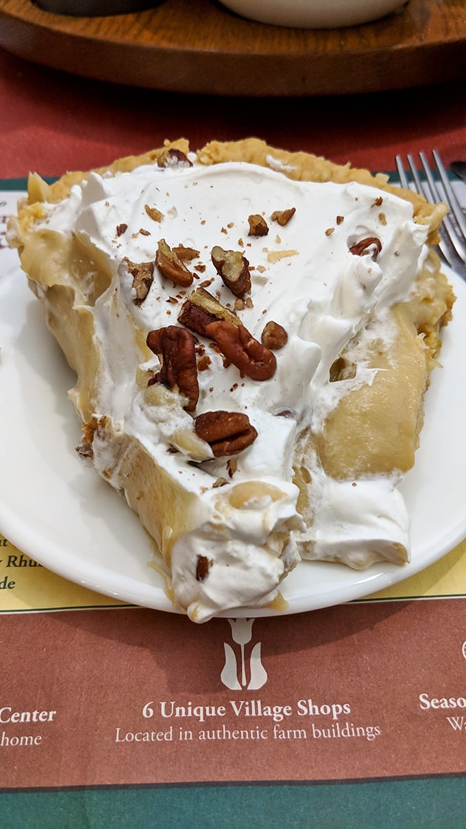 This isn't just pie—it's a towering monument to the art of dessert-making, with pecans standing guard over layers of creamy perfection.