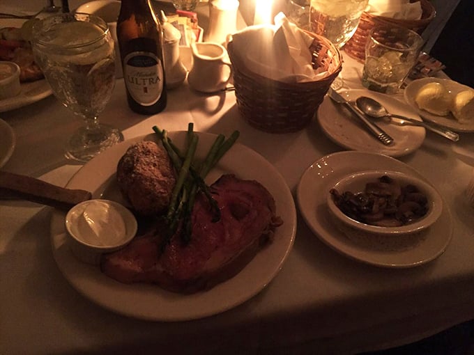 Candlelight dining at its finest—prime rib cooked to that perfect shade of pink that makes meat lovers go weak in the knees.