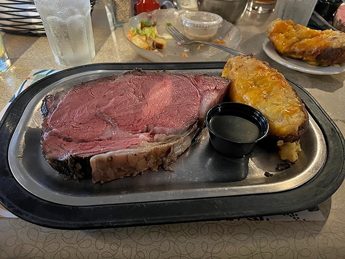 Prime rib so perfectly pink it should be on a magazine cover. That baked potato isn't just a side—it's a worthy companion.