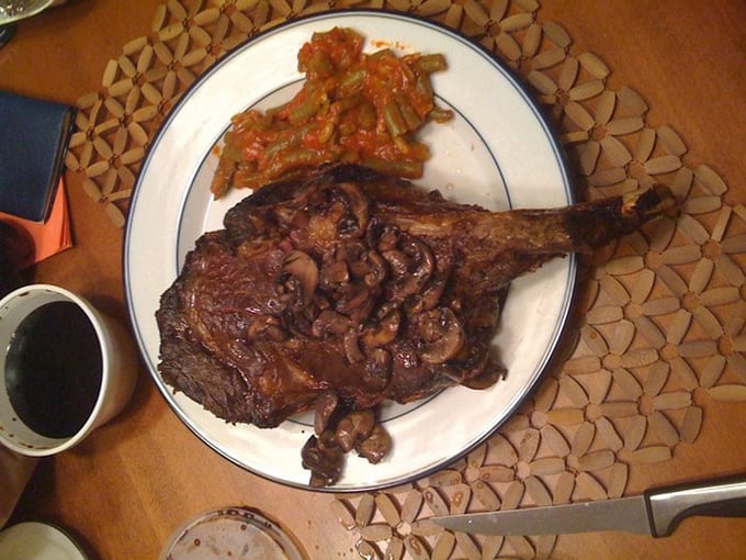 That ribeye isn't just dinner—it's wearing a crown of sautéed mushrooms like it knows exactly how royal it truly is.