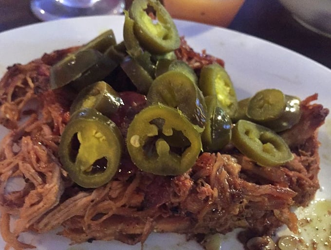 Pulled pork topped with jalapeños—a spicy crown for the king of barbecue meats. Each strand tells a story of patient smoking and tender care.