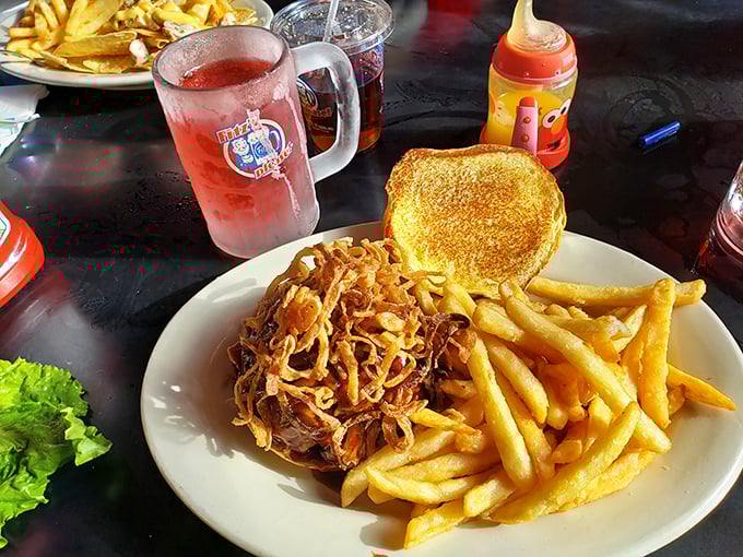 Pulled pork piled high with crispy fries on the side—this isn't just a sandwich, it's what happiness would look like if it took physical form.