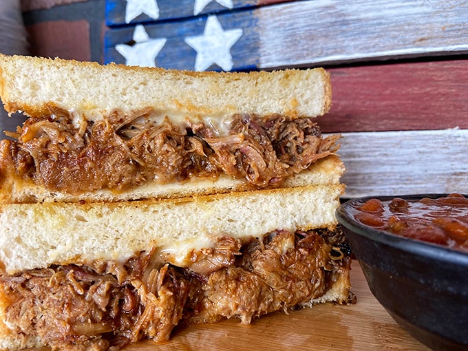 The pulled pork sandwich – where smoke-kissed strands of pork meet Texas toast in a relationship so perfect, it should have its own reality show.