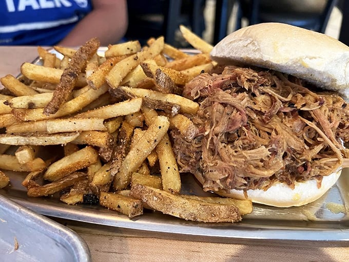 The pulled pork sandwich – where seasoned meat meets soft bun in a relationship so perfect it should have its own reality show.