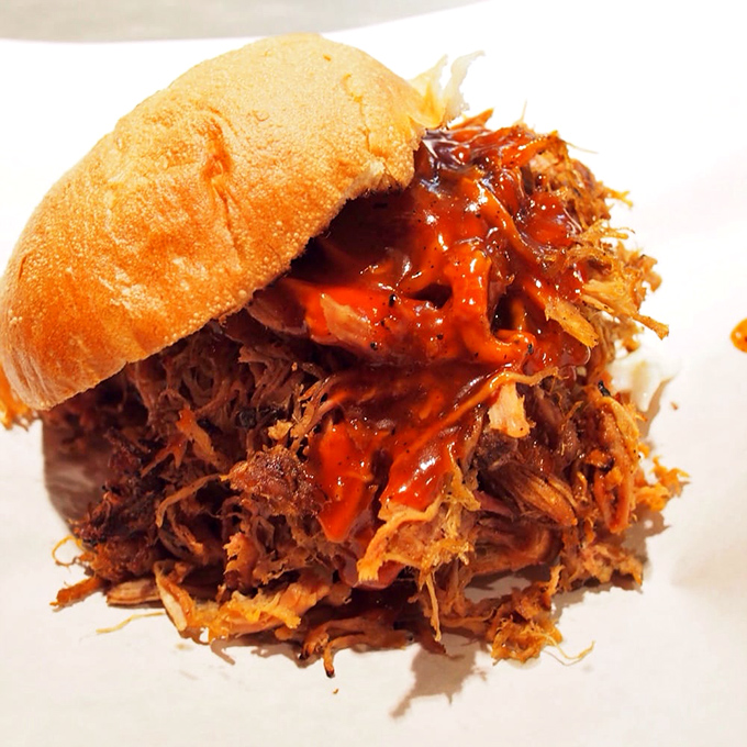 The pulled pork sandwich doesn't just satisfy hunger – it resolves existential crises with each tender, sauce-soaked bite.