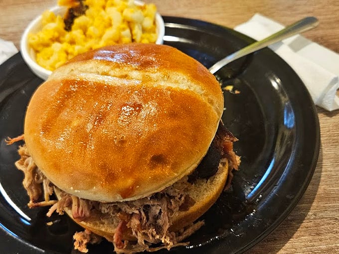 This pulled pork sandwich isn't just a meal—it's an engineering marvel of tender meat and soft bun. The mac and cheese sidekick steals scenes.