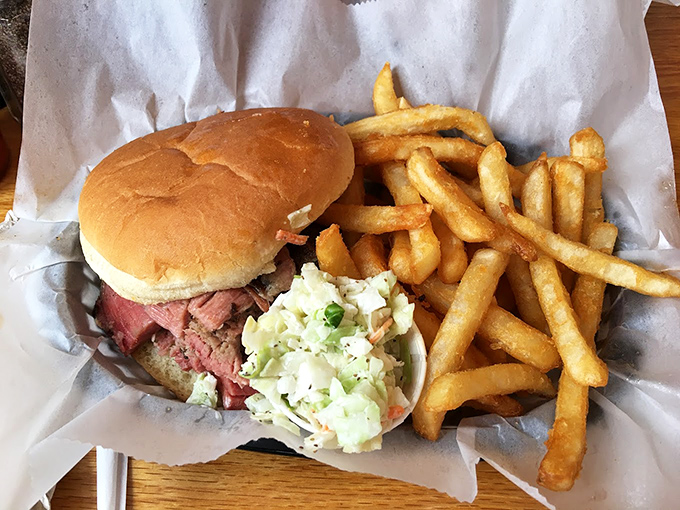 The pulled pork sandwich—where smoke-kissed meat meets pillowy bun in perfect harmony. Those fries aren't just sides; they're essential companions.