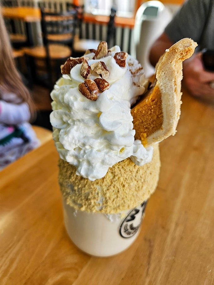 Dessert architecture at its finest! This towering shake combines creamy ice cream with crunchy toppings for a spoon-and-straw masterpiece.