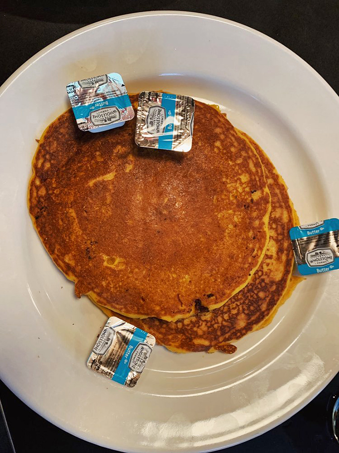 These pancakes aren't just breakfast, they're an event – golden discs adorned with butter medallions like a delicious game of edible checkers.