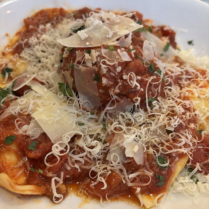 Ravioli crowned with shaved parmesan and bathed in rich sauce—proof that the simplest pleasures are often the most profound.