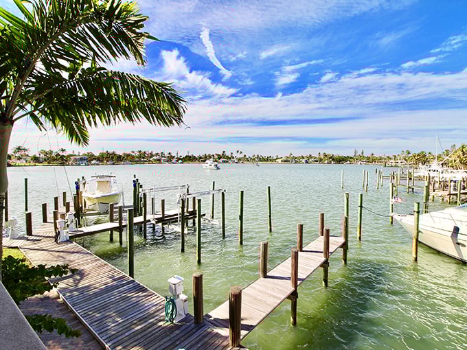 The marina's wooden docks create a geometric ballet of lines and reflections – each slip a parking space for someone's floating piece of freedom.