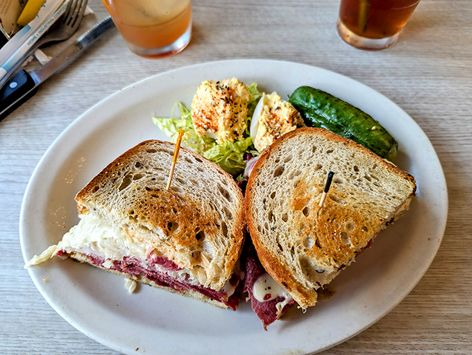 The Reuben sandwich—where corned beef, sauerkraut, and Swiss cheese perform a perfectly choreographed dance on grilled rye. The pickle is your backstage pass.
