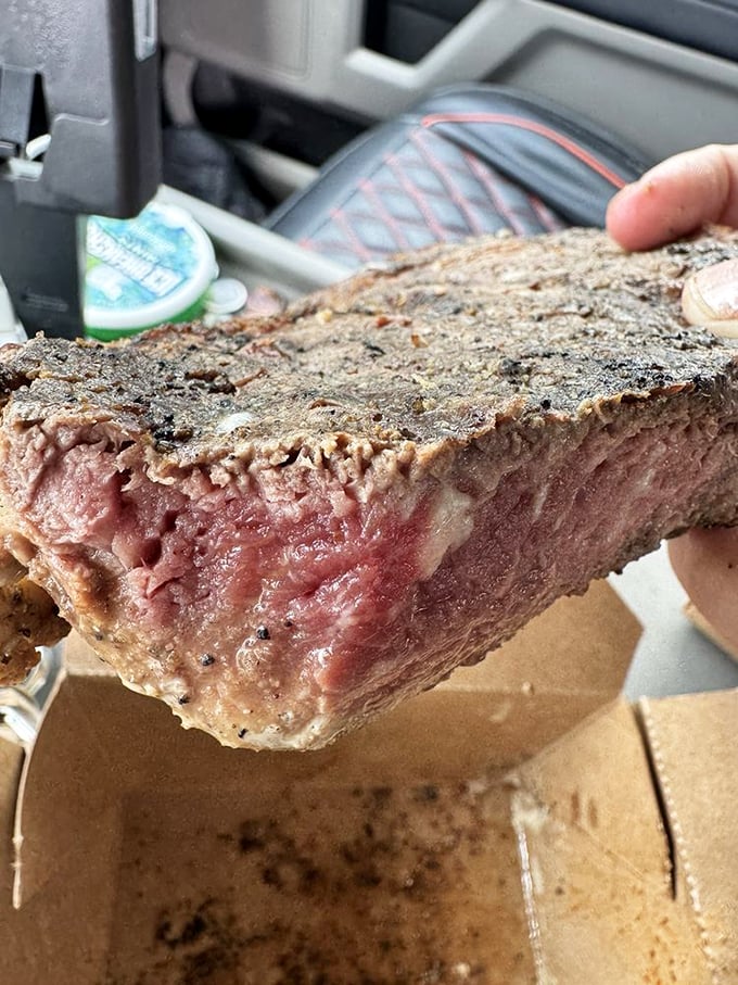 That cross-section reveals the steak equivalent of winning the lottery—perfect marbling, ideal doneness, and enough juiciness to require extra napkins.