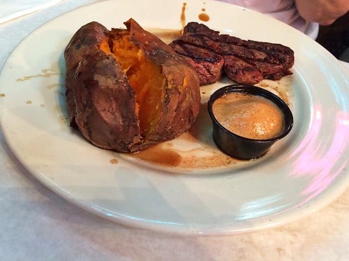 Steak and sweet potato—a romance for the ages. That sauce cup isn't just sitting there for decoration; it's waiting to elevate each bite to heavenly status.