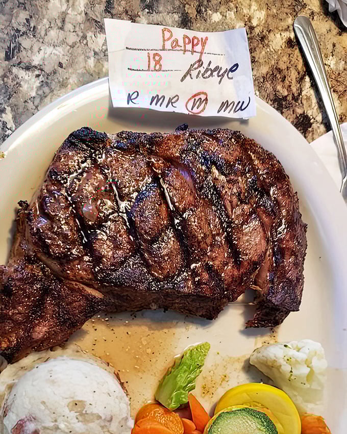 The ribeye arrives with a handwritten order ticket—a personal touch that says, "Yes, we cooked this specifically for you, not some anonymous steak enthusiast."