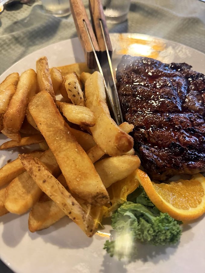 A perfectly seared ribeye with fries that could make a Frenchman weep—simple perfection that needs no translation.