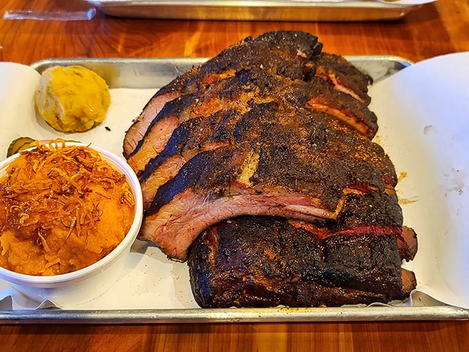 Behold the brisket—sporting that coveted pink smoke ring and a bark so perfect it deserves its own hall of fame.