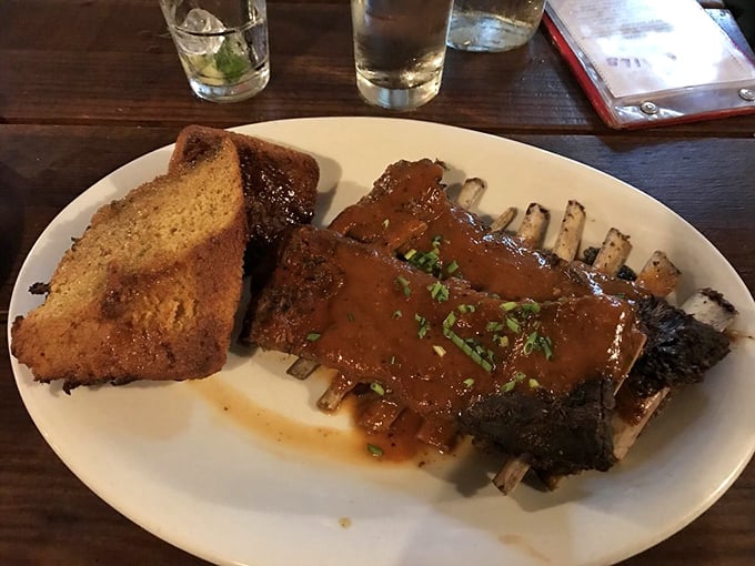 These ribs don't just fall off the bone—they practically leap into your mouth, trailing their rich, glossy sauce behind them.