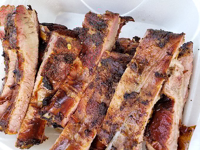 These ribs have the kind of smoke ring that makes barbecue enthusiasts weak in the knees. The bark alone tells stories of patient, loving preparation.