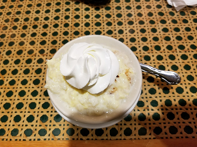 Rice pudding that would make your grandmother both proud and jealous. That dollop of whipped cream on top isn't optional—it's essential architecture.