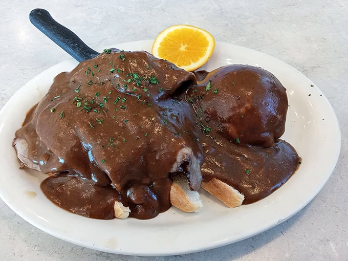 This hot roast beef sandwich isn't just lunch—it's therapy on a plate, complete with gravy generous enough to make your cardiologist wince.