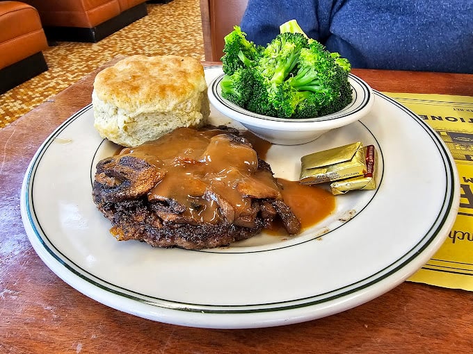 This isn't just a hamburger steak—it's therapy on a plate. The mushroom gravy has secrets that should probably be classified by the Pentagon.