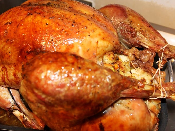 This isn't just roast turkey—it's Thanksgiving's greatest hit, available year-round, glistening with the kind of juices that make paper napkins utterly useless.