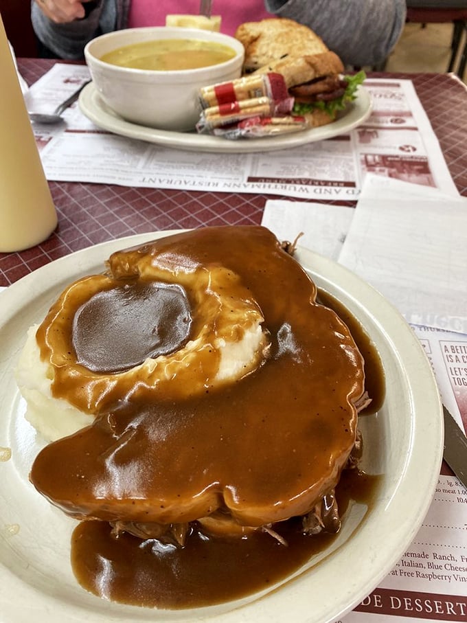 Behold, the hot roast beef sandwich—where gravy isn't just an addition, it's a philosophy. Comfort food that hugs you from the inside.