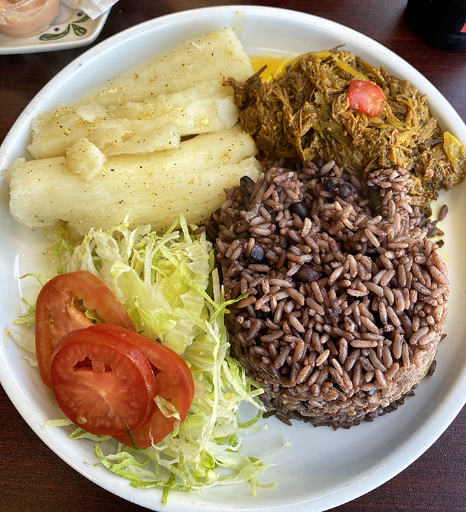 Ropa vieja with yuca and rice—tender shredded beef that's been slow-dancing with spices so long they've practically exchanged vows.