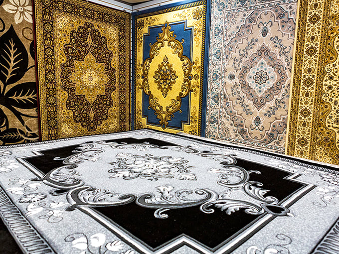 Carpet showroom displaying patterns vibrant enough to make your living room jealous of everyone else's.