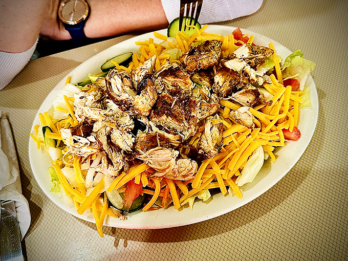 A salad that doesn't apologize for being delicious – grilled chicken atop a bed of fresh ingredients that even vegetable skeptics can embrace.