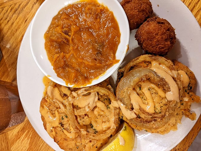 Crispy croquettes drizzled with secret sauce sit alongside what appears to be she-crab soup—a Southern duet that sings of coastal Carolina.