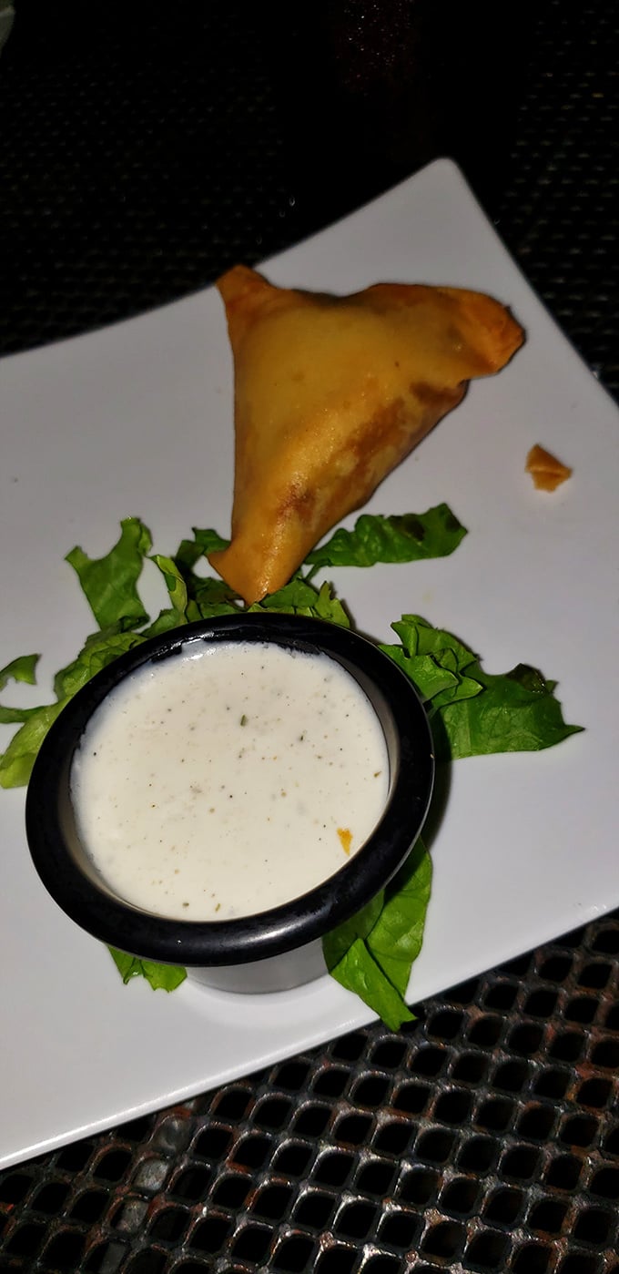 The golden samosa – crispy, triangular perfection served with cooling mint sauce. Britain's greatest culinary import since, well, tea.