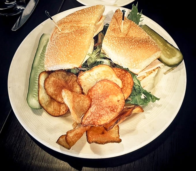 Crispy house-made chips flank a sandwich that's built for satisfaction, not Instagram—though it deserves the spotlight anyway.