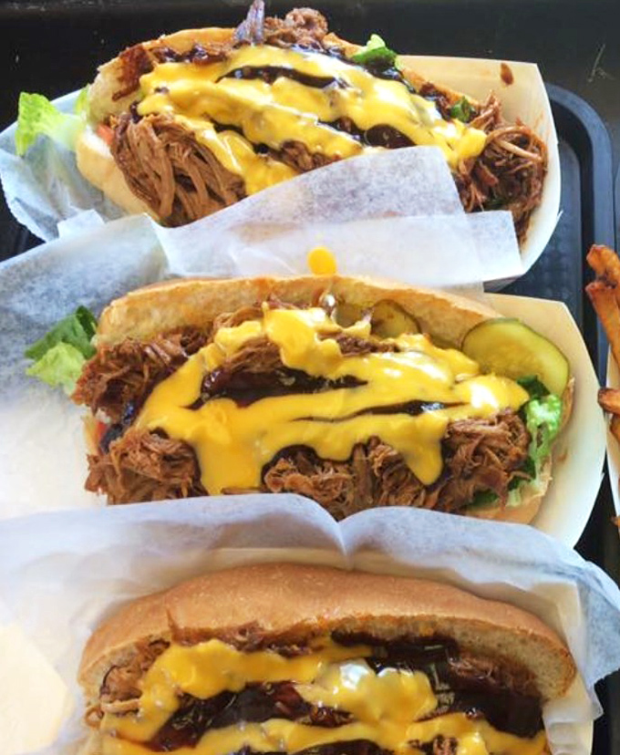 Pulled pork sandwiches dressed with cheese that don't need fancy plating – they're too busy preparing for their brief but meaningful relationship with your taste buds.