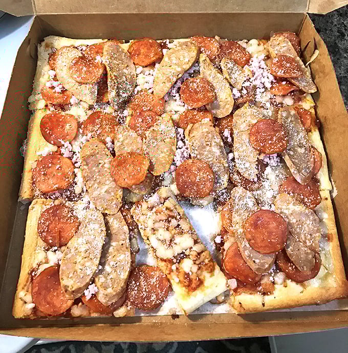 The sausage and pepperoni combo creates a meat-lover's masterpiece on that signature square crust – a flavor symphony conducted by decades of experience.
