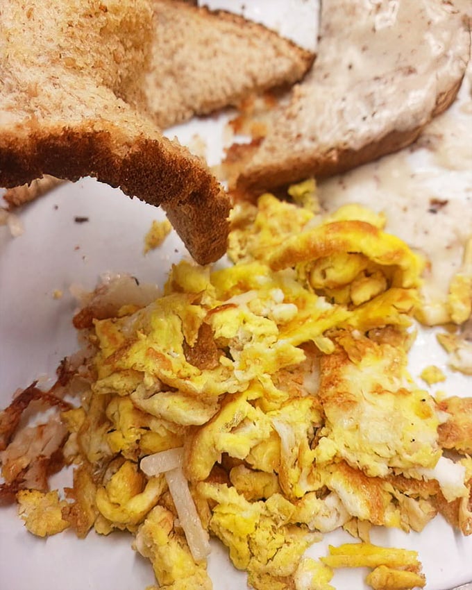 Scrambled eggs done right – fluffy, tender, and actually tasting like eggs. Paired with toast, it's the breakfast equivalent of a warm hug.