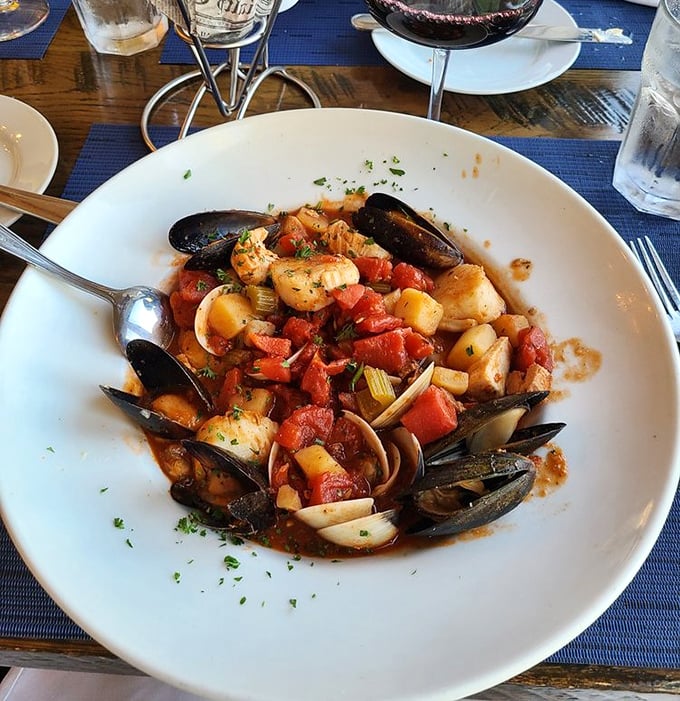The seafood muddle brings together mussels, shrimp, and fish in a tomato broth so good you'll be plotting how to drink it without anyone noticing your lack of spoon etiquette.