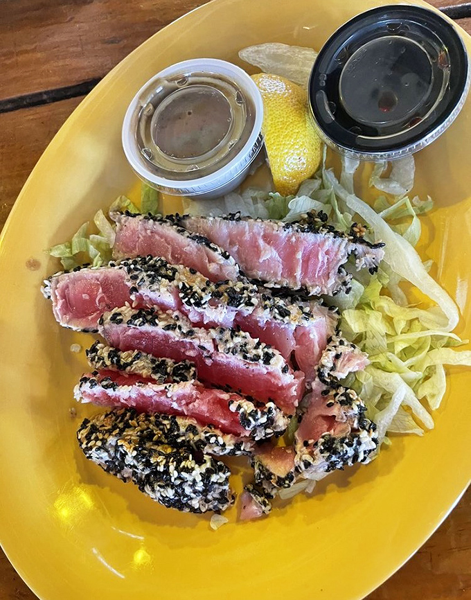 Sesame-crusted tuna, seared rare and sliced like jewels—proof that sometimes the simplest preparations showcase the ocean's bounty most eloquently.