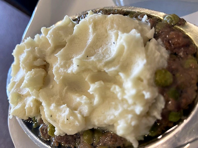 Shepherd's pie that would make actual shepherds abandon their flocks – a bubbling cauldron of savory goodness topped with cloud-like mashed potatoes.