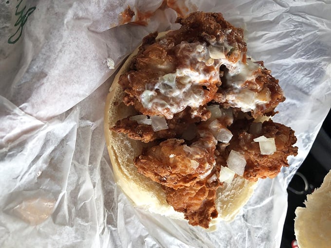 Fried shrimp sandwich that looks like it's trying to escape its bread prison. Don't worry – your stomach is a much nicer place to end up.