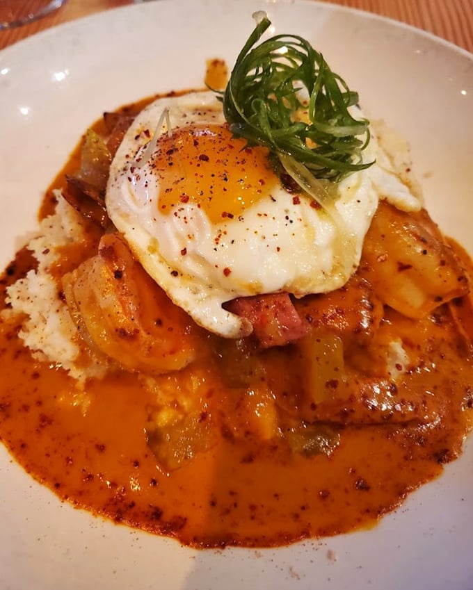 Comfort food elevated to art form – a sunny-side egg crowns this hearty dish like a culinary halo. Your grandmother would approve, then ask for seconds.