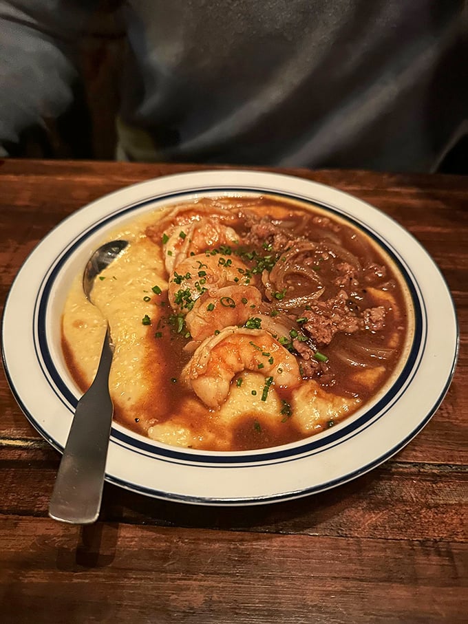 The legendary shrimp and grits – plump crustaceans nestled in creamy cornmeal heaven with a sauce so good you'll contemplate drinking it directly.